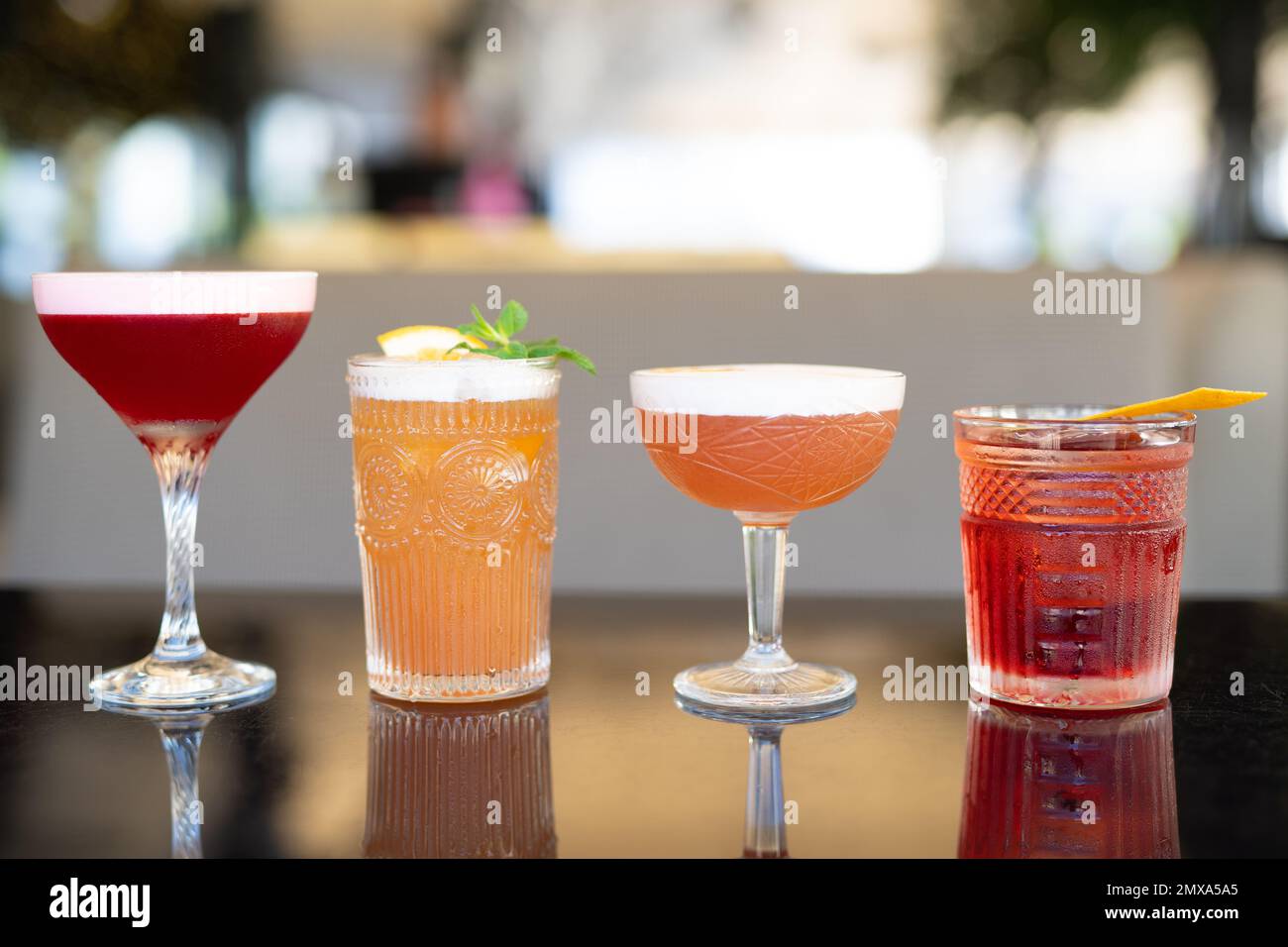beautiful and delicious alcoholic cocktails prepared at the bar by the ...