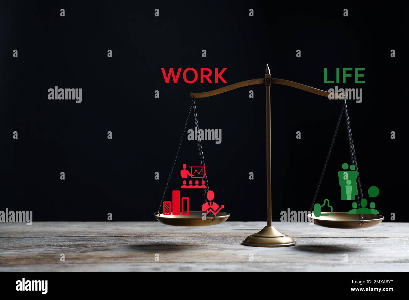 Work-life balance concept. Scale with images on table Stock Photo - Alamy