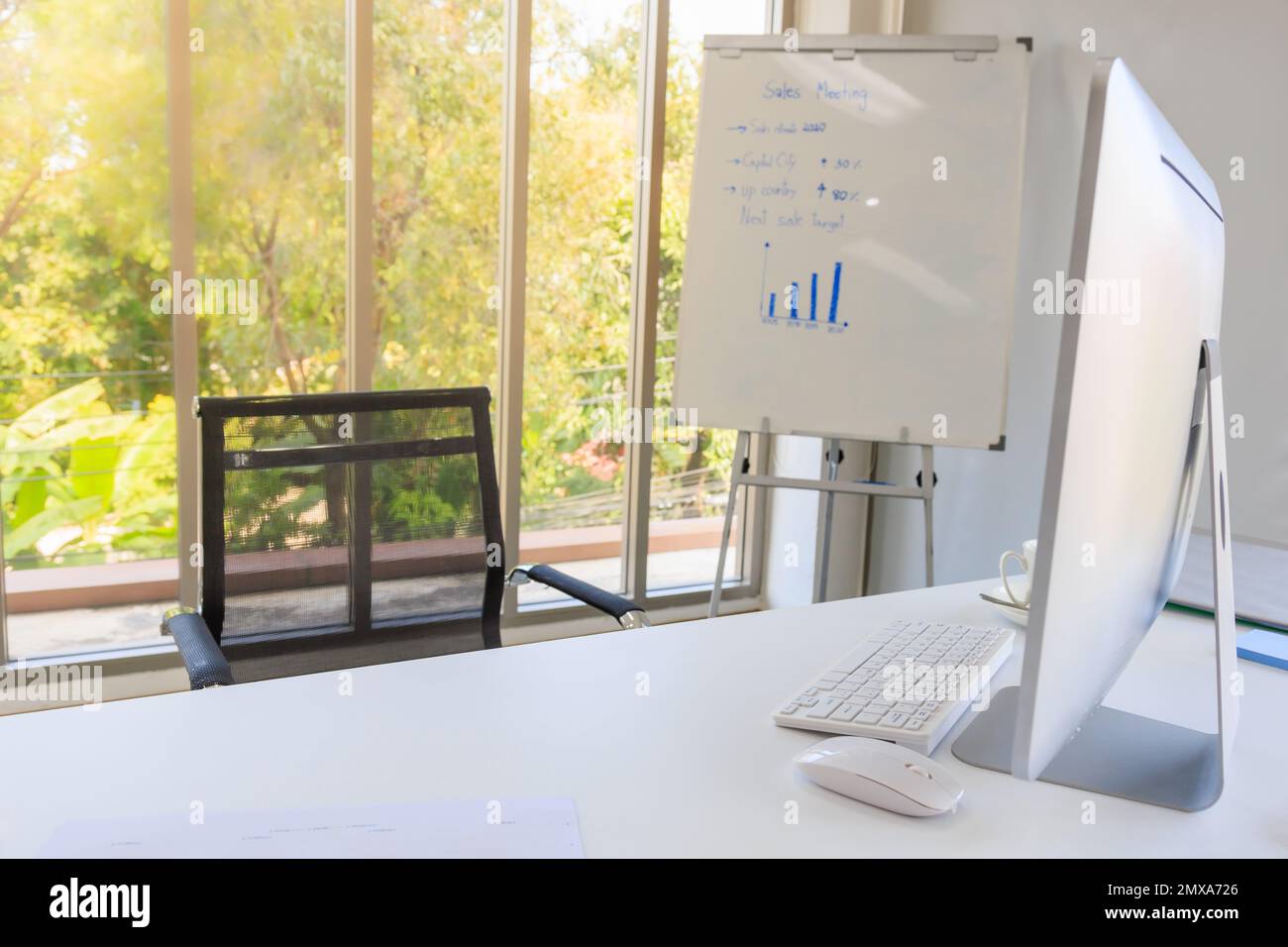 View of office room with desktop computer, keyboard, mouse, meeting ...