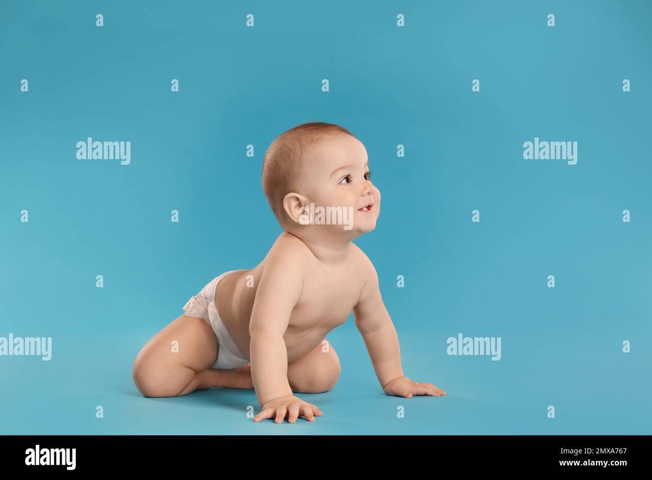 Cute little baby in diaper on light blue background Stock Photo - Alamy