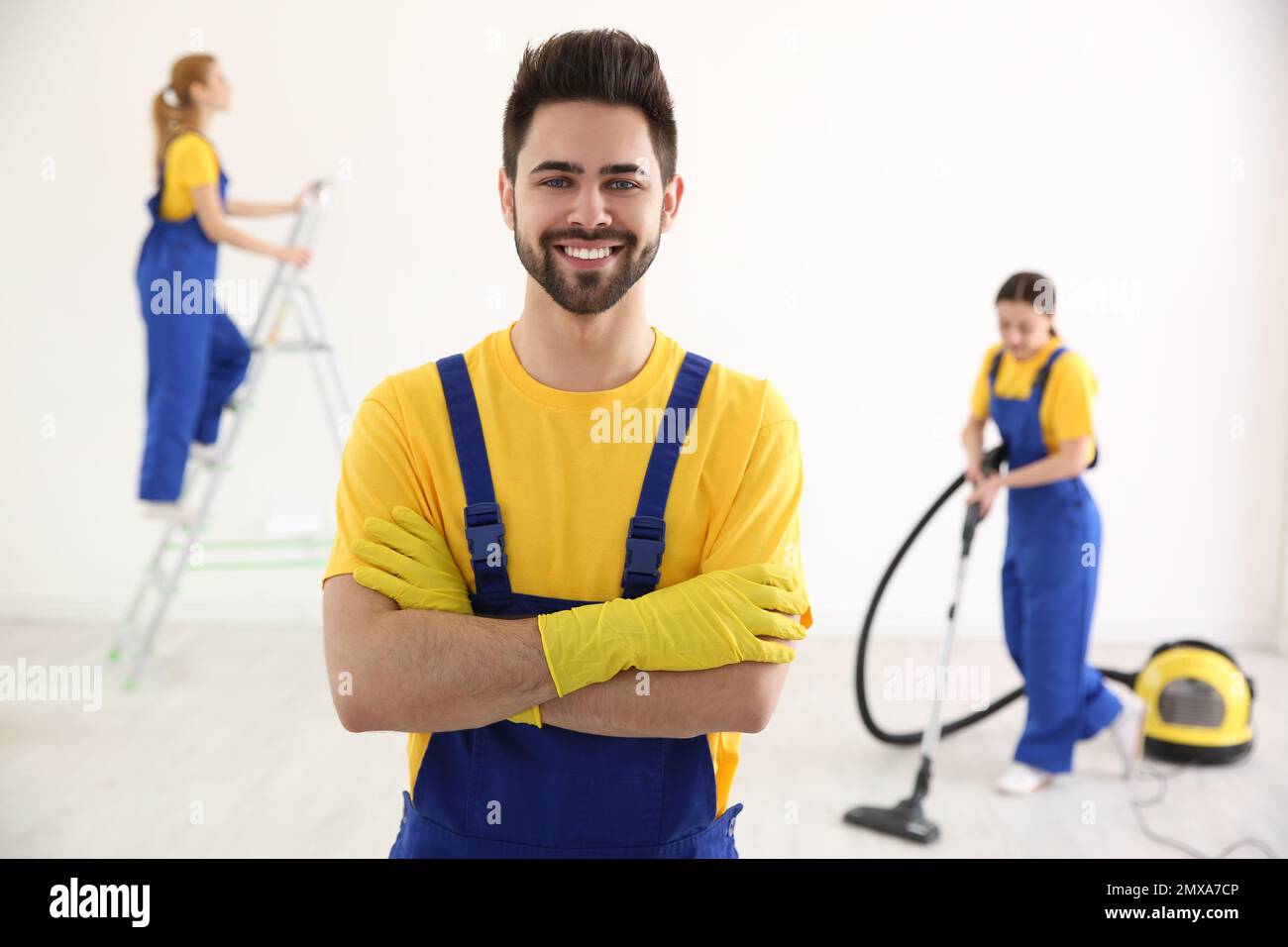 Professional janitor in uniform indoors. Cleaning service Stock Photo ...