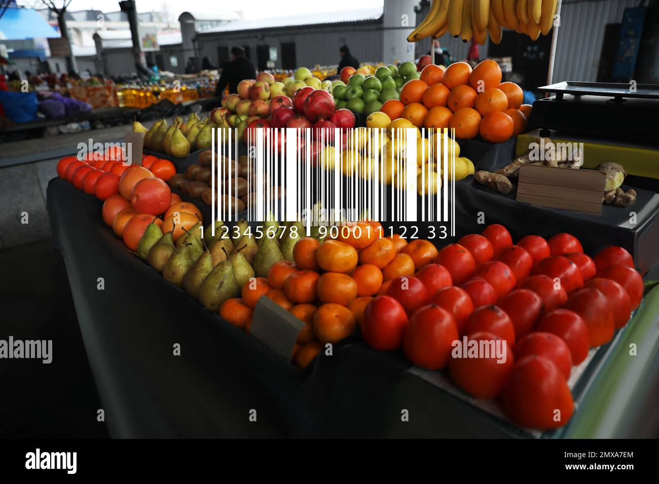 Barcode and tasty fresh fruits on counter at wholesale market Stock ...