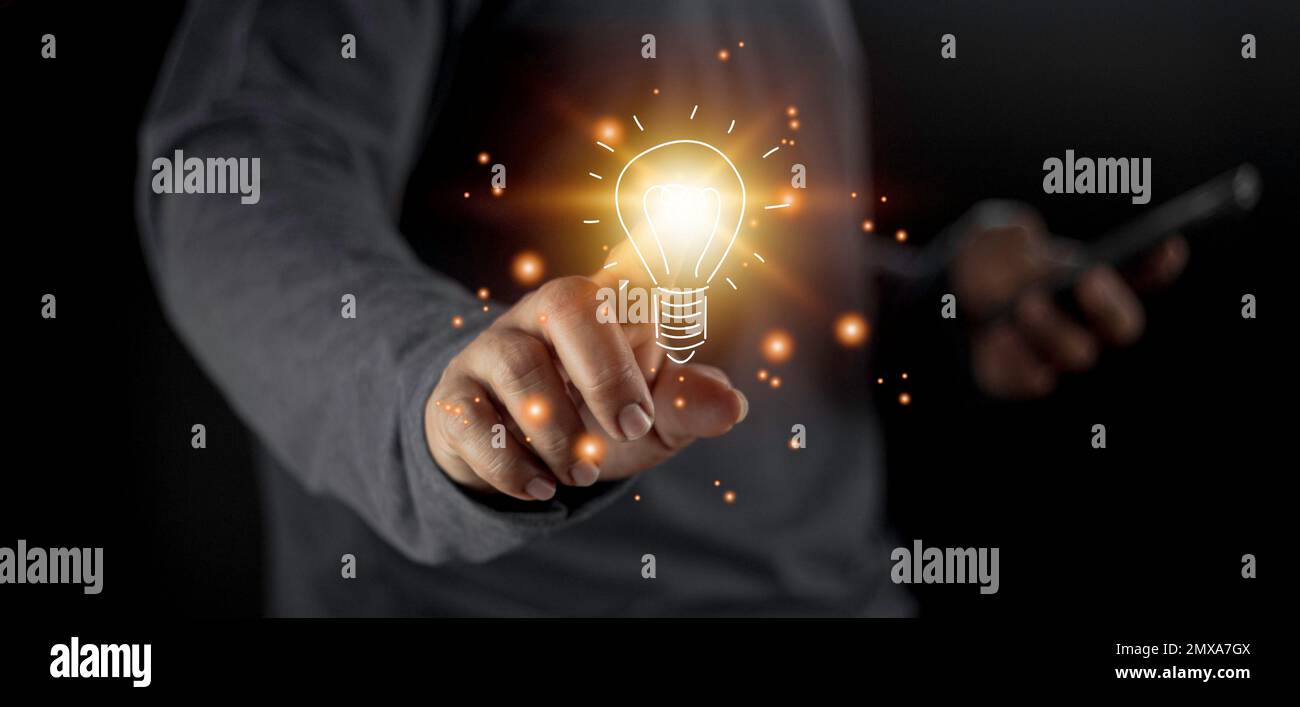 hand holding light bulb. idea concept with innovation and inspiration ...