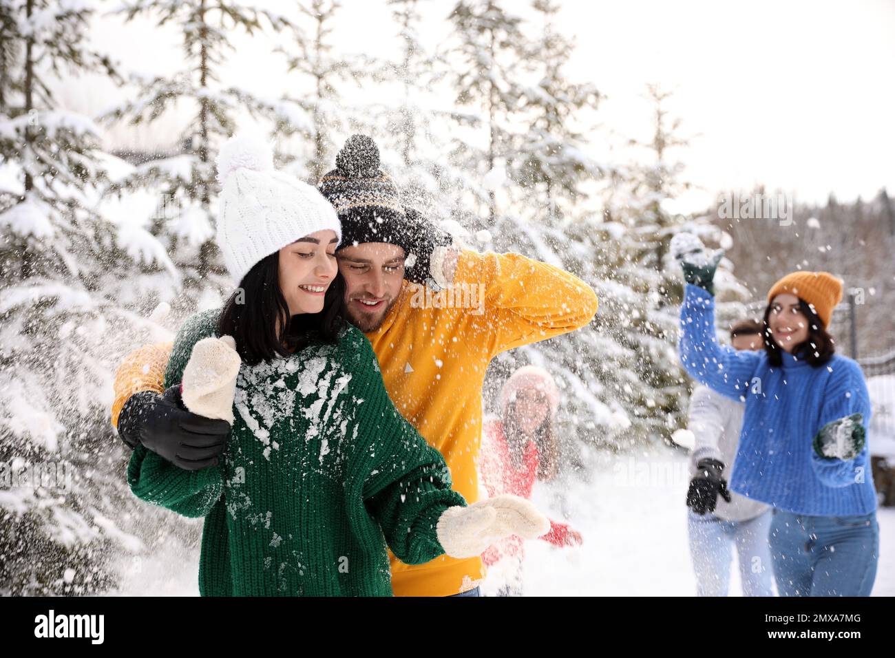 Group of friends playing snowballs outdoors. Winter vacation Stock ...