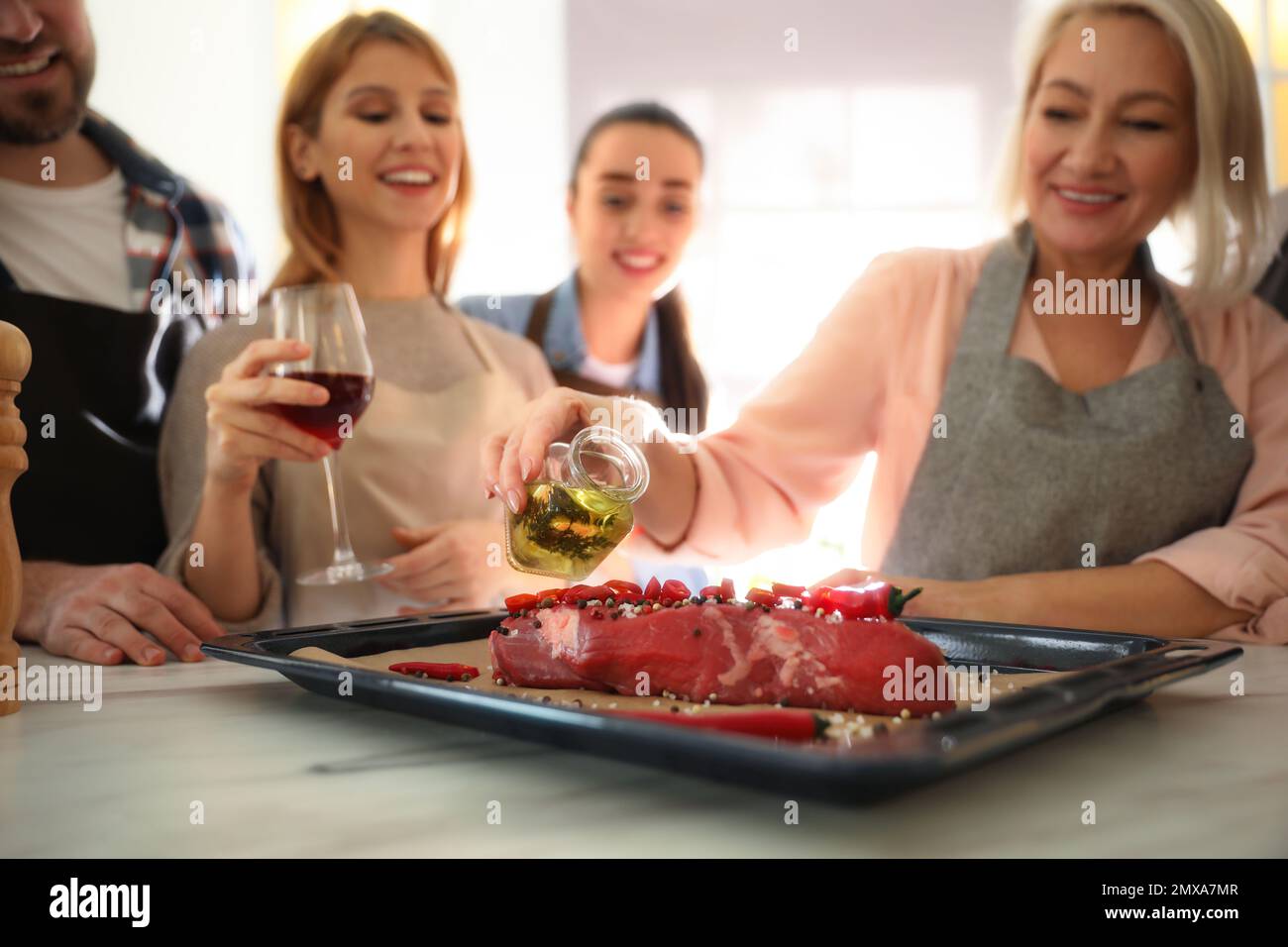 Happy people cooking food together in kitchen Stock Photo - Alamy