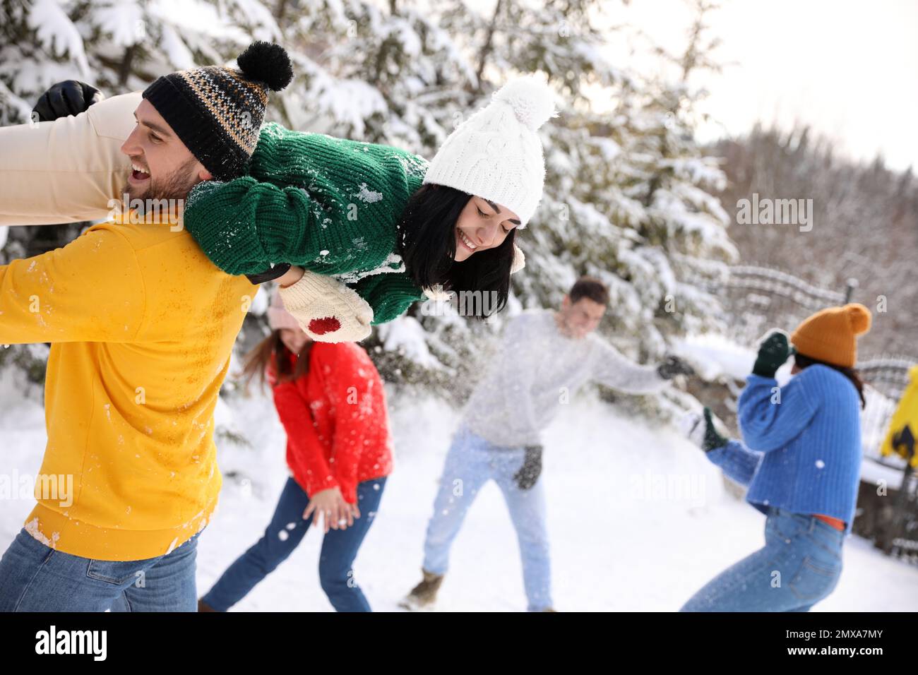 Group of friends playing snowballs outdoors. Winter vacation Stock ...