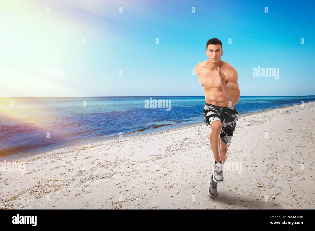 Athletic young man running near sea on sunny day, space for text Stock ...