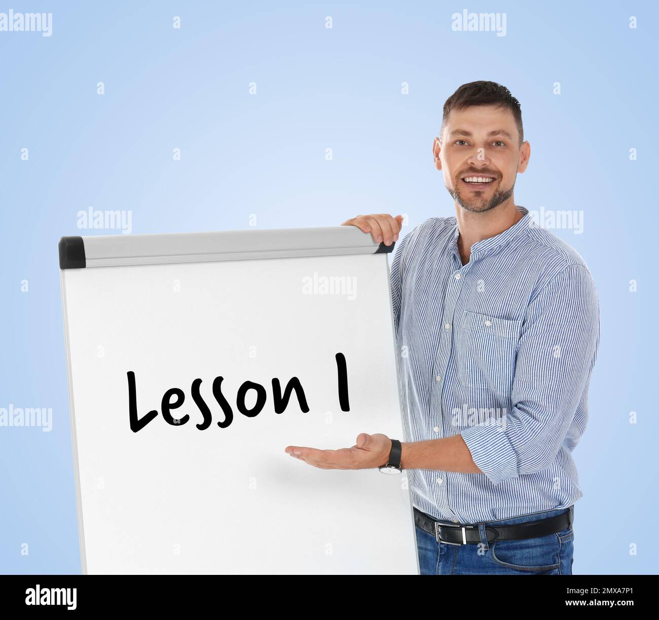 English teacher near flip chart board on light blue background Stock ...