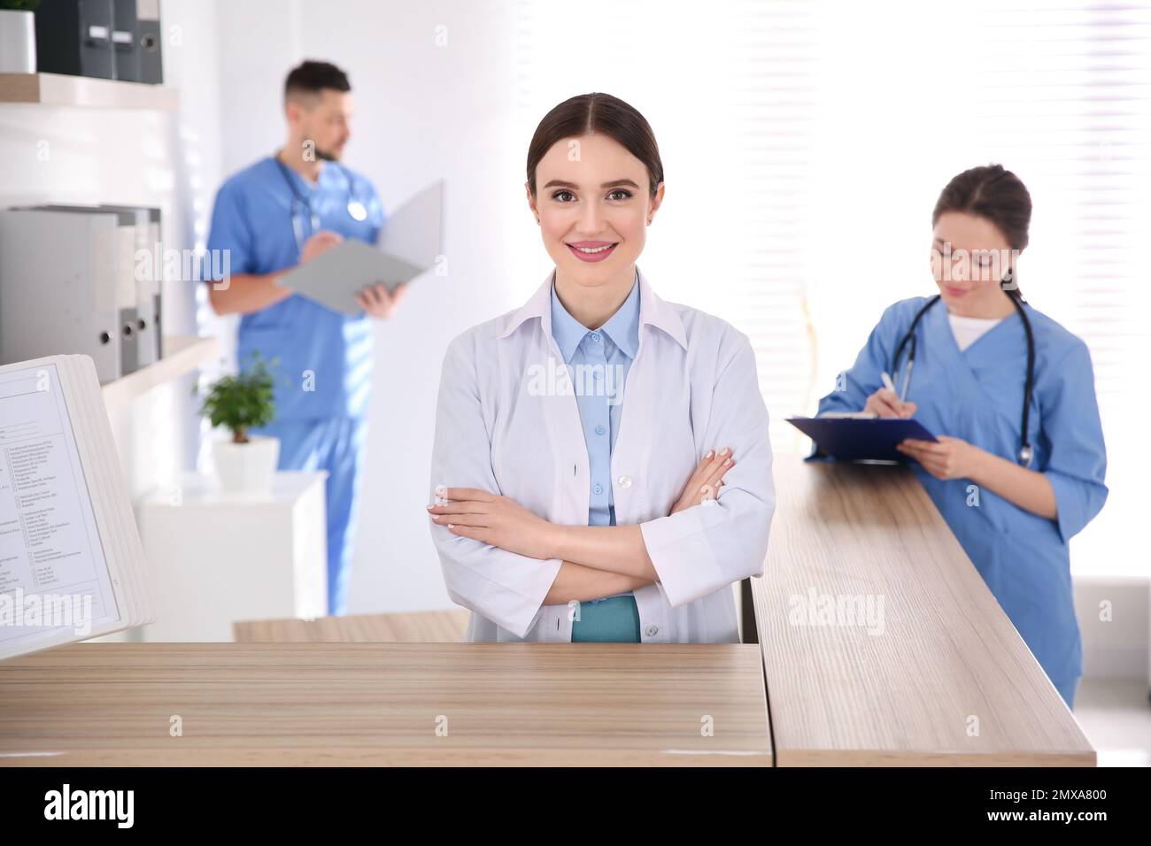 Portrait of female doctor at counter in modern clinic Stock Photo - Alamy