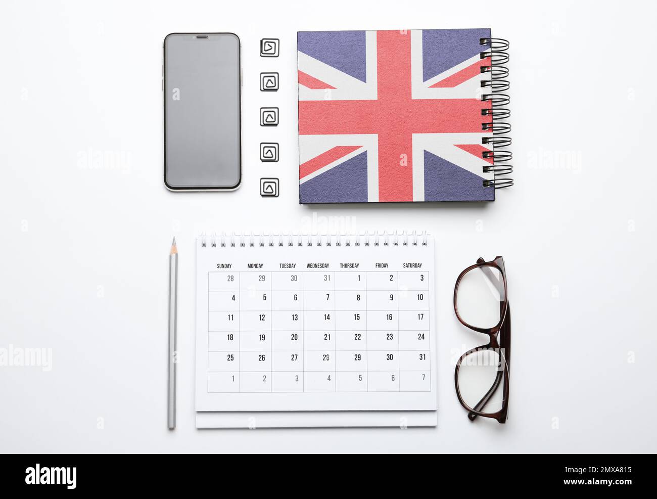 Calendar, notebook, glasses and mobile phone on white background, top ...