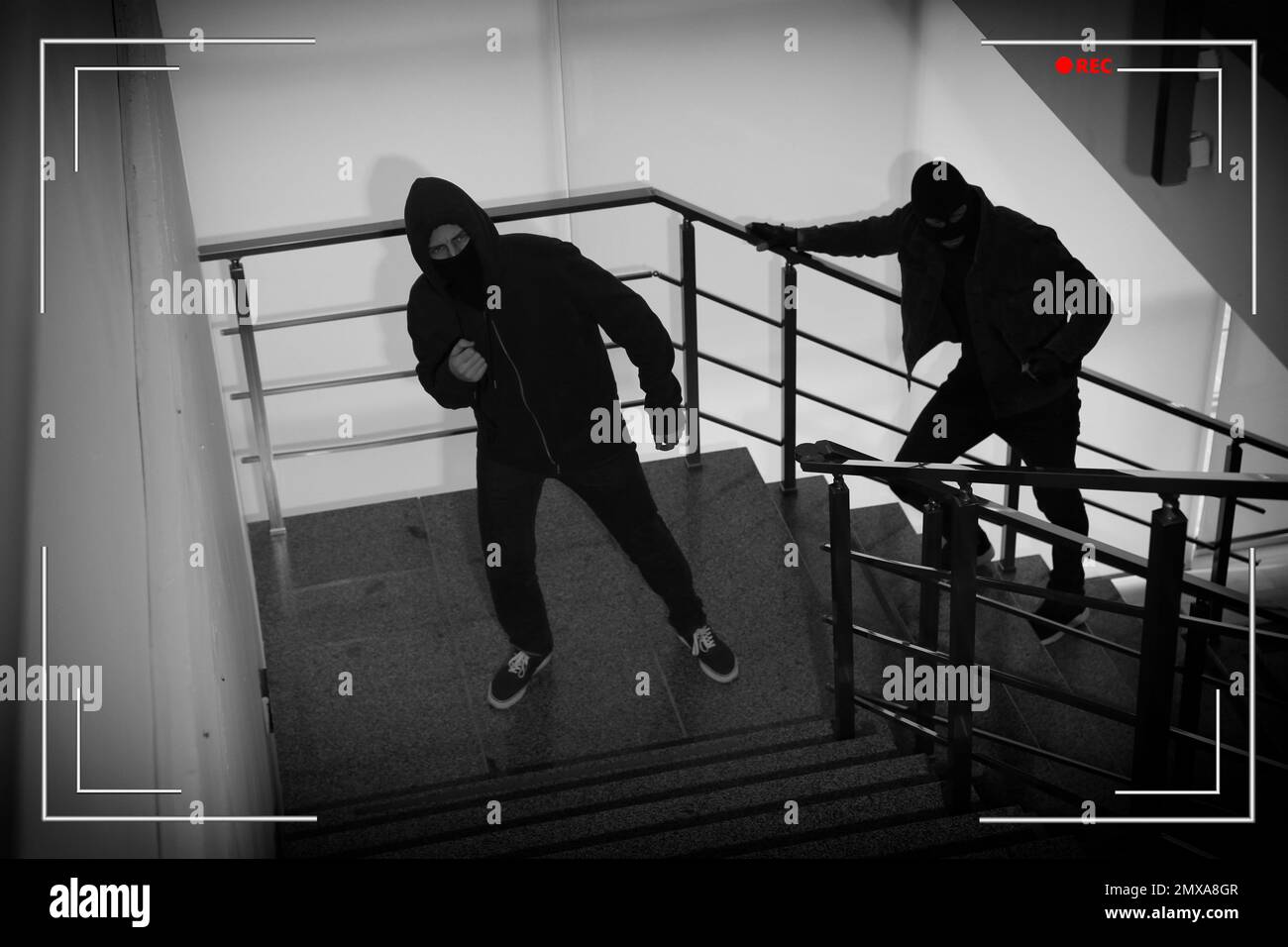 Criminals in masks on stairs indoors, view through CCTV camera Stock ...