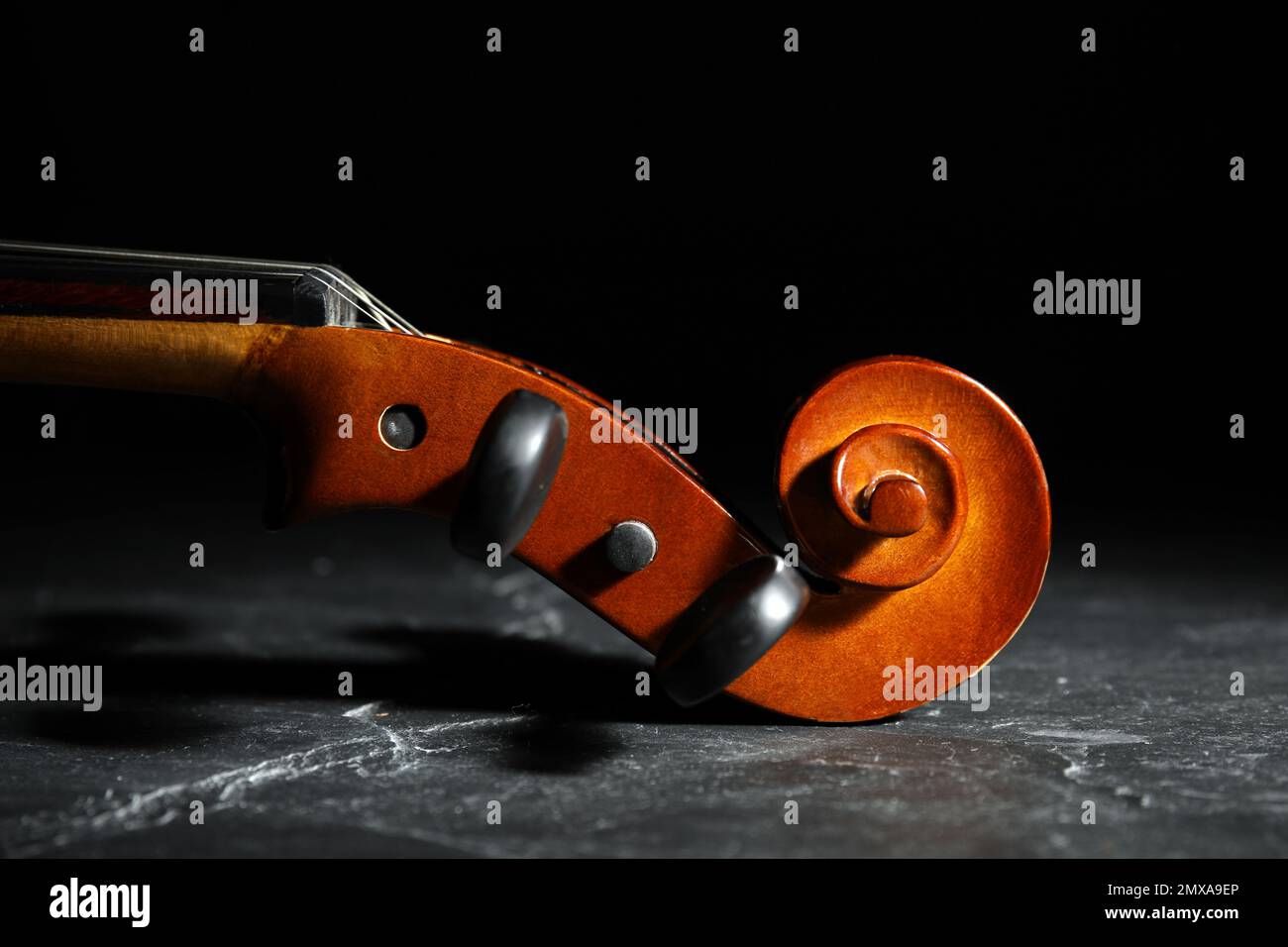Classic violin on stone table against black background, closeup Stock ...
