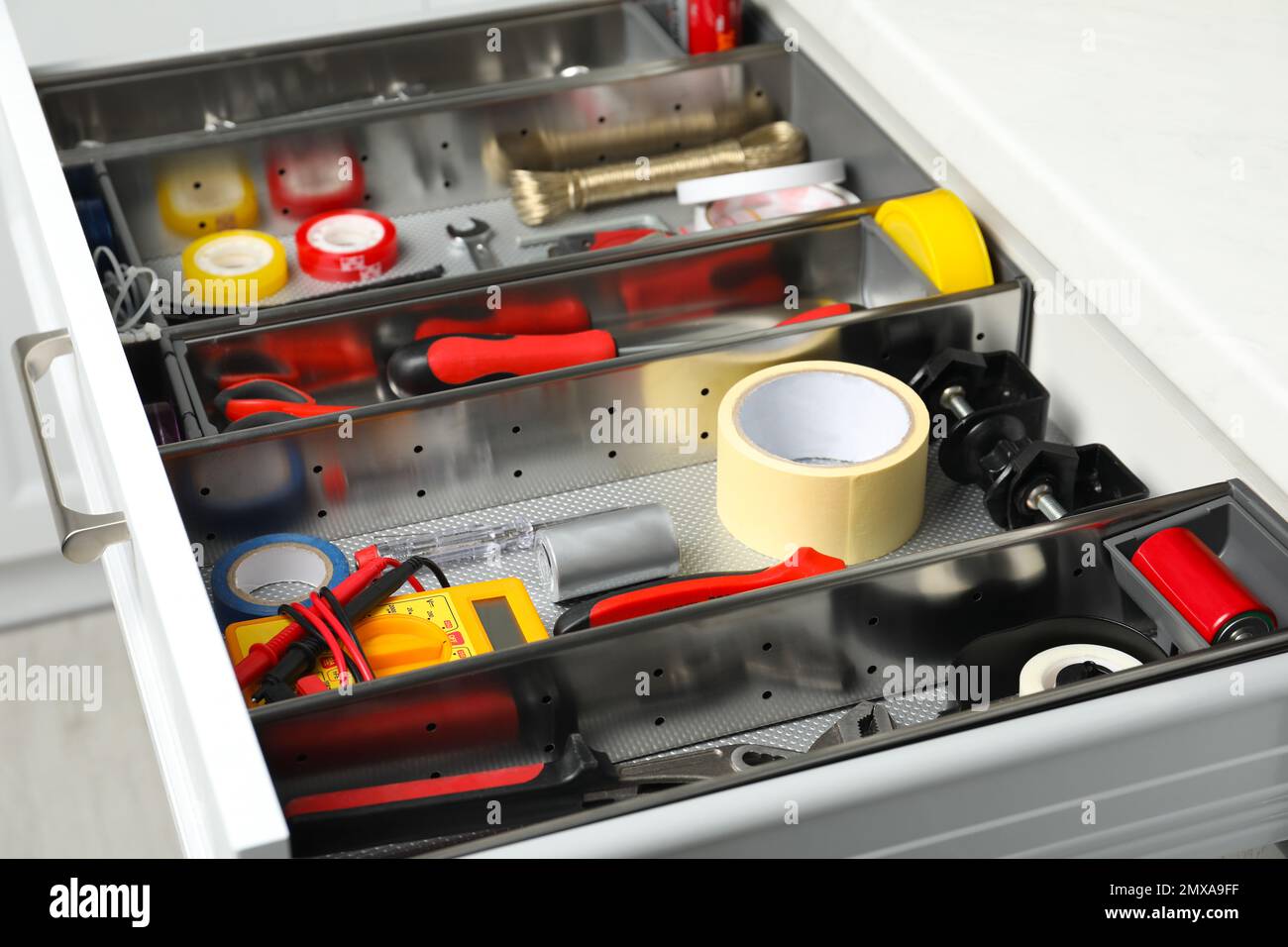Set of instruments in open desk drawer indoors Stock Photo - Alamy