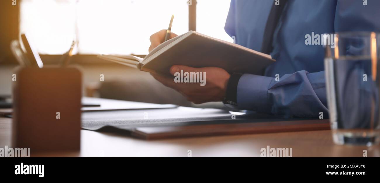Male lawyer working at table in office, closeup. Banner design Stock ...