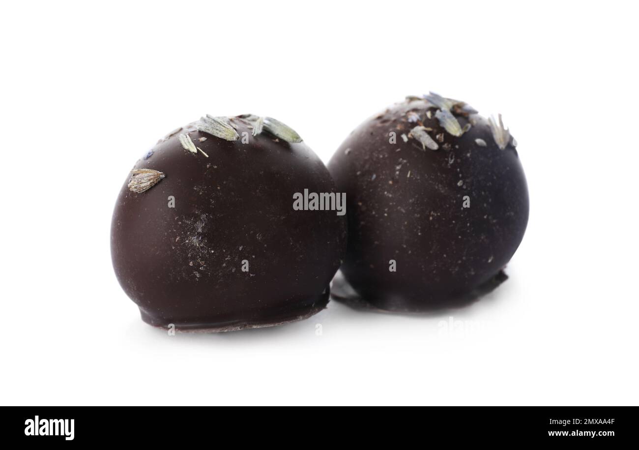 Delicious dark chocolate candies isolated on white Stock Photo - Alamy