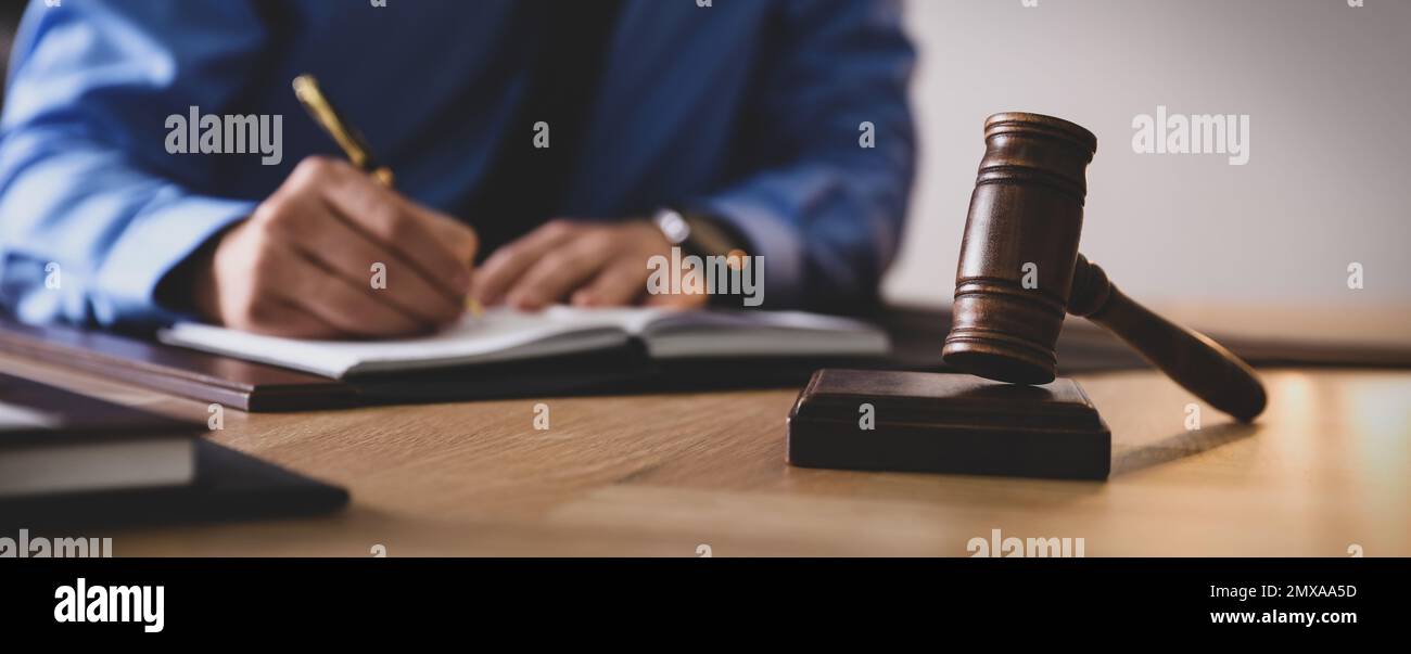 Male lawyer working at table in office, focus on gavel. Banner design ...