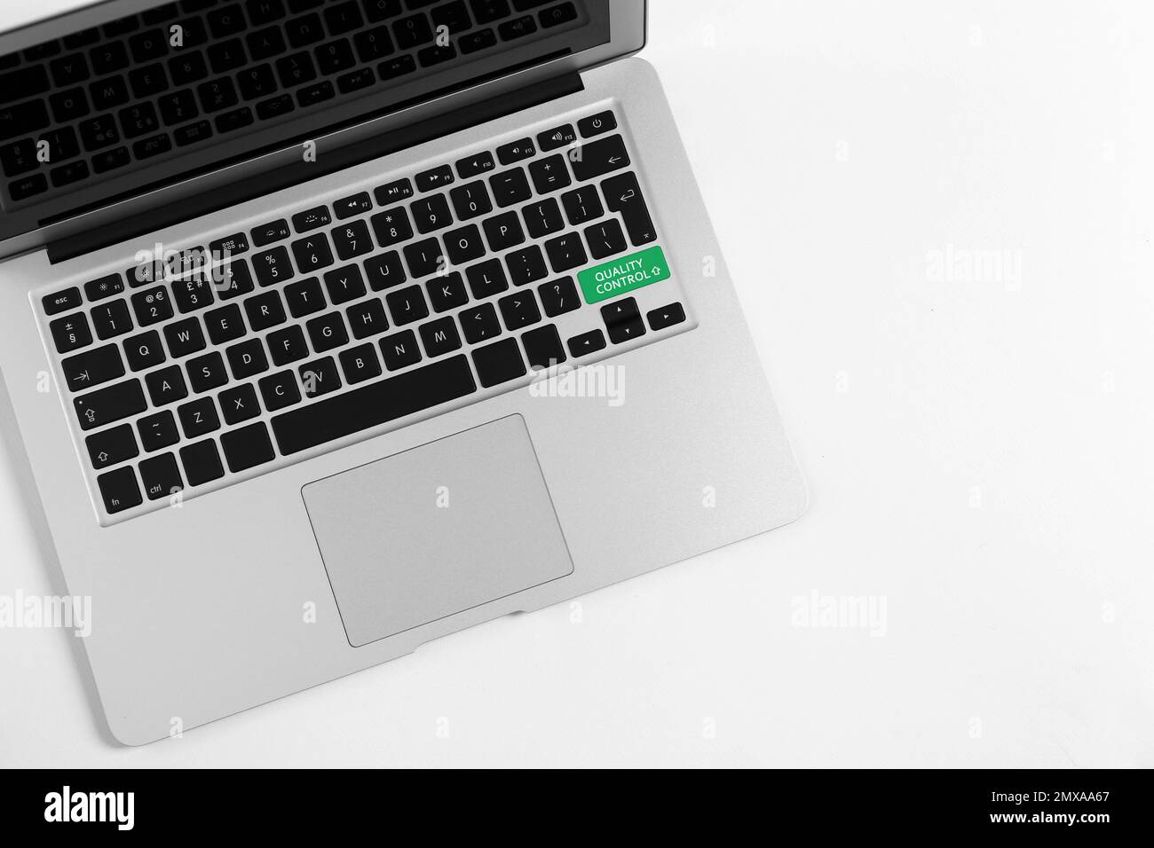Modern laptop with quality control button isolated on white, top view ...