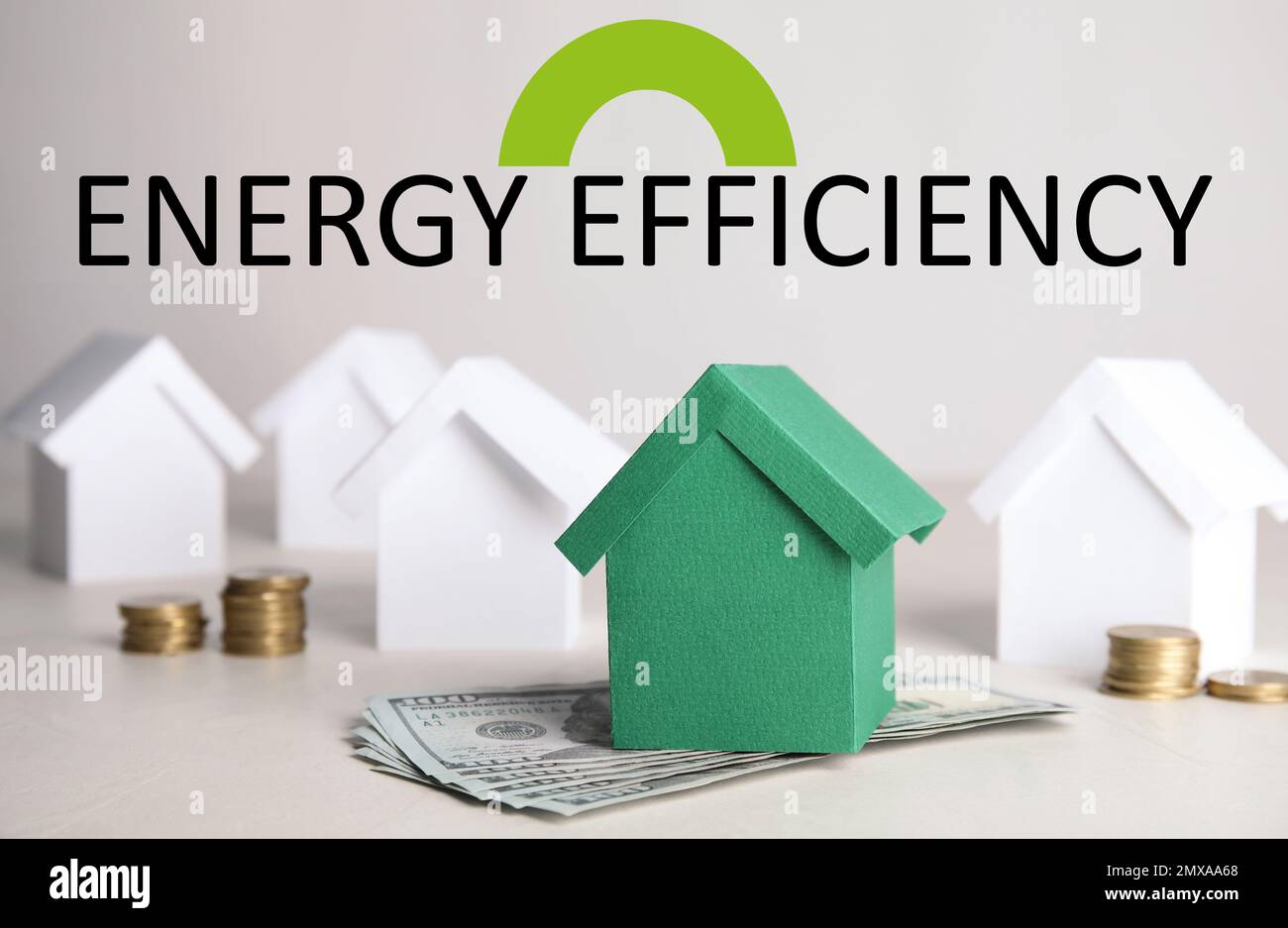 Energy efficiency concept. Green and white house models with money on ...