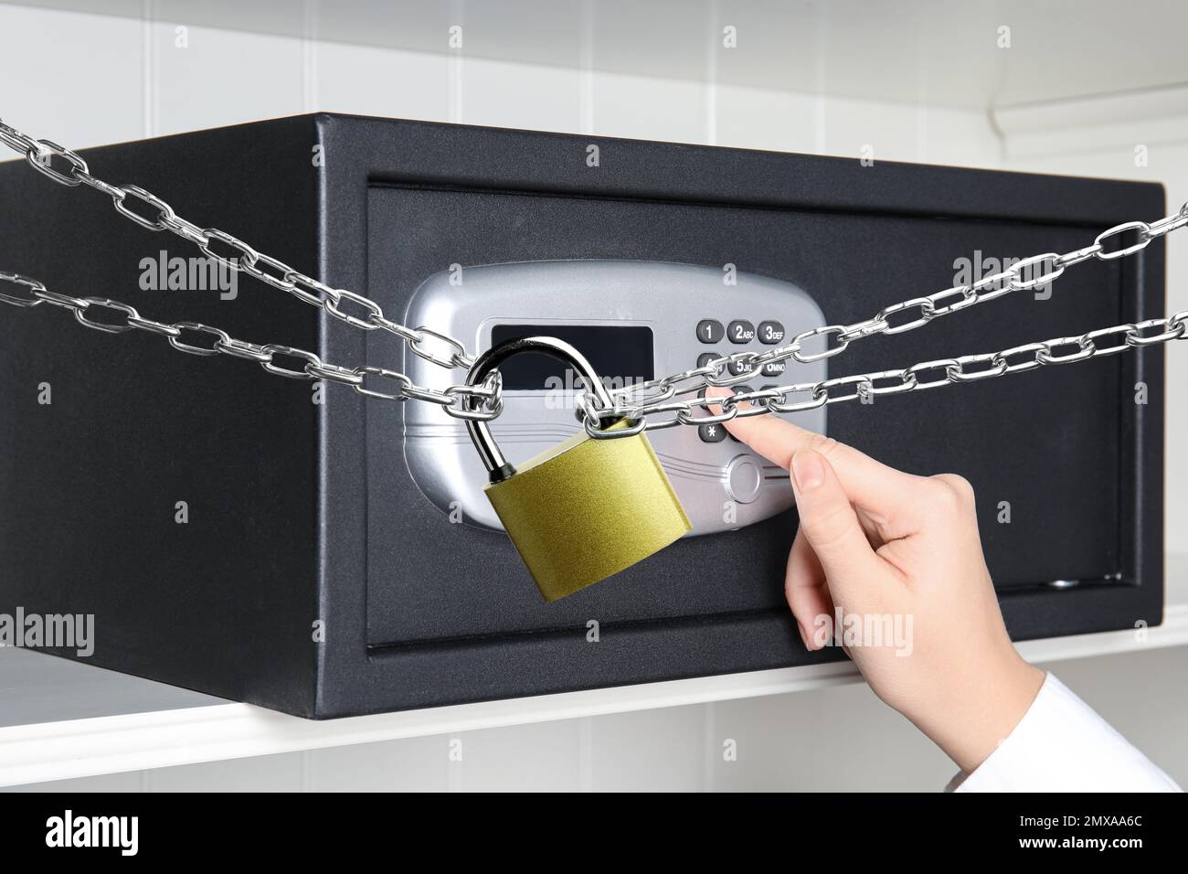 Woman opening steel safe with electronic lock, closeup Stock Photo - Alamy