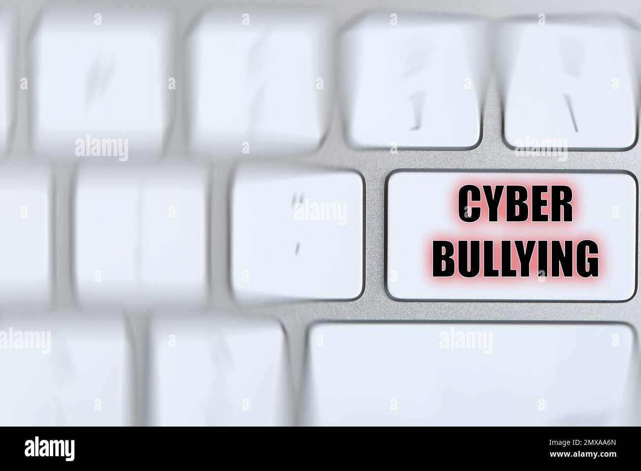 Top view of defocused laptop keyboard and phrase CYBER BULLYING on ...
