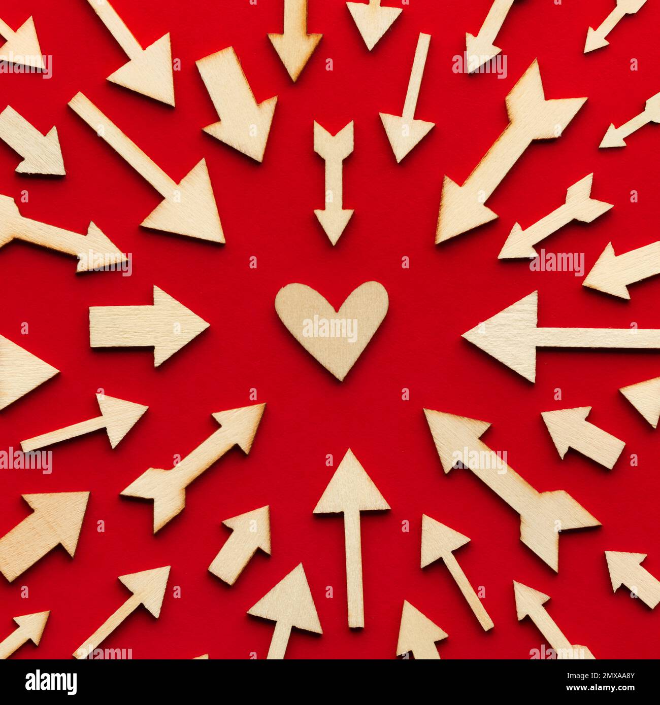 Dozens of arrows pointing at a single heart. Romantic concept with ...