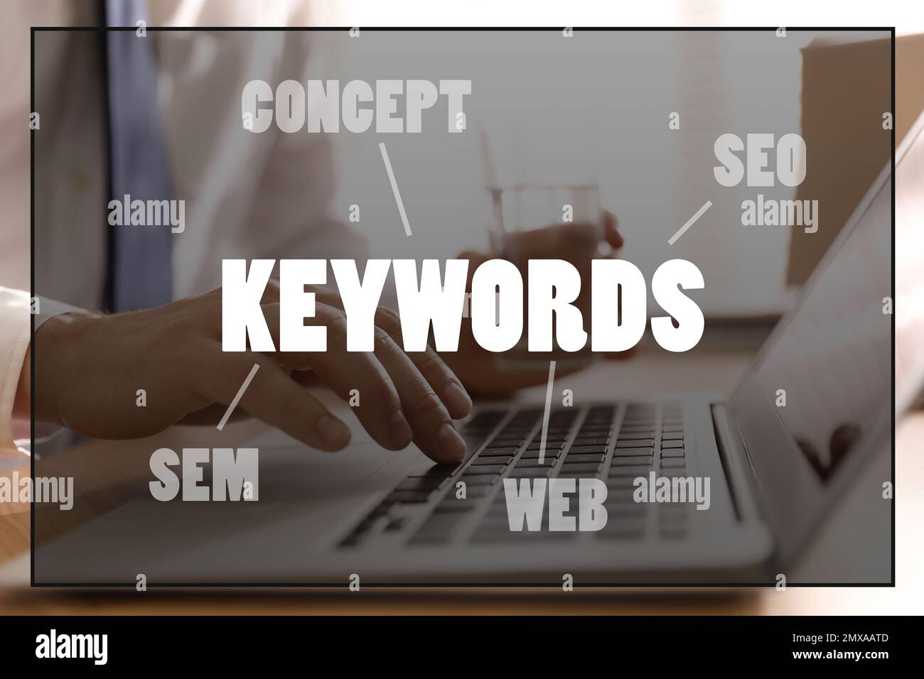 Man working with laptop and scheme of keywords research, closeup Stock ...