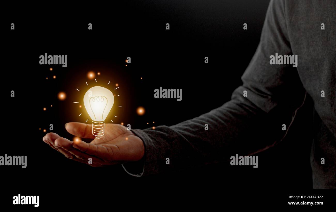hand holding light bulb. idea concept with innovation and inspiration ...
