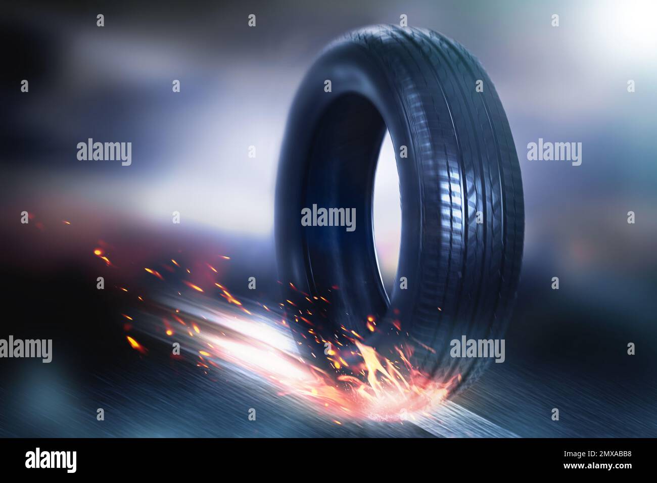 Car tire with flame rolling on road against blurred background Stock ...