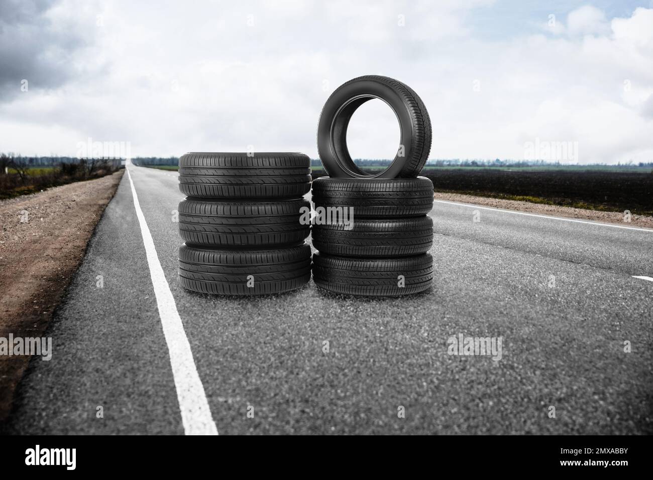 Stacks of car tires on asphalt highway outdoors Stock Photo - Alamy