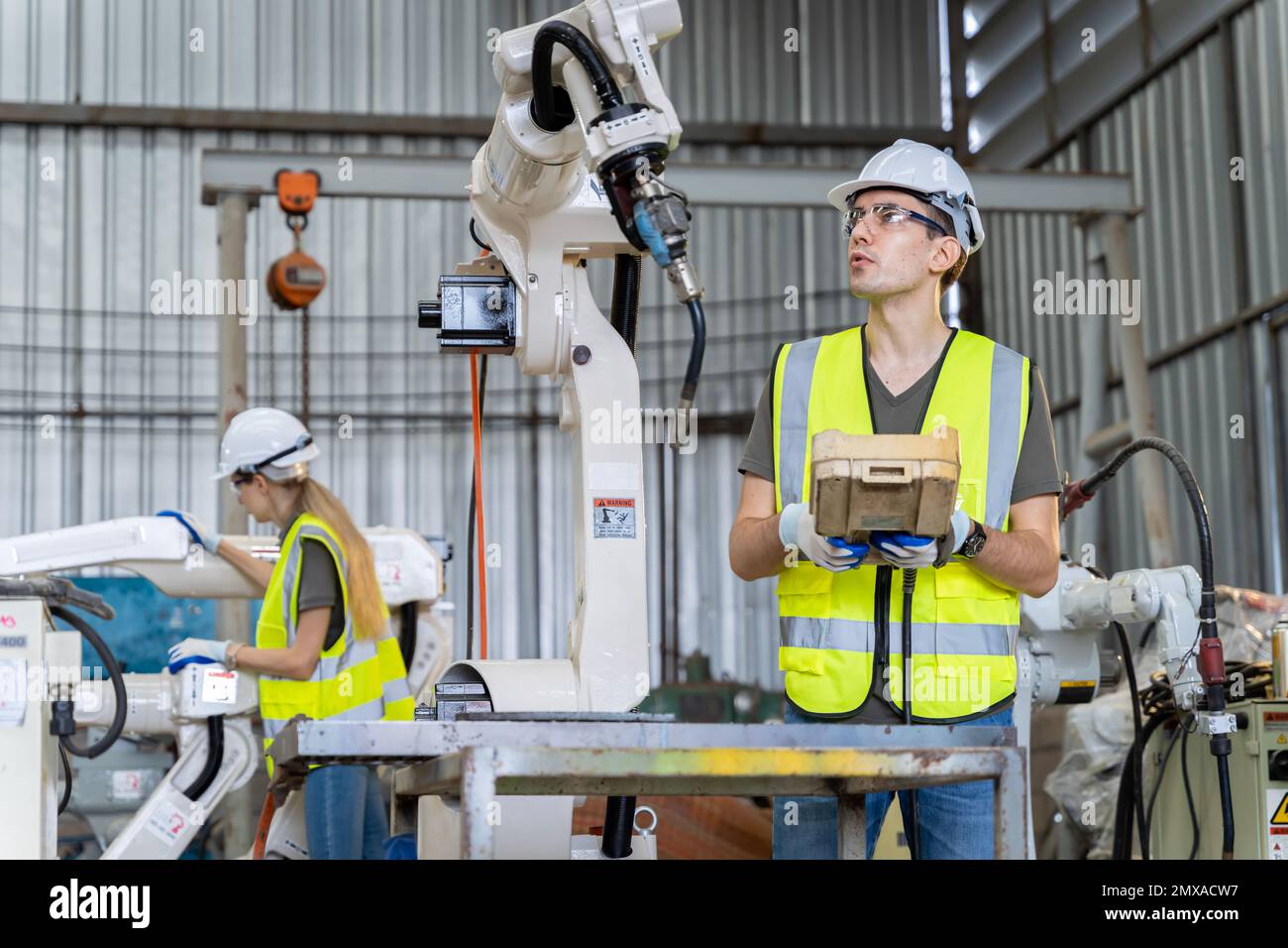 A team of male and female engineers meeting to inspect computer ...