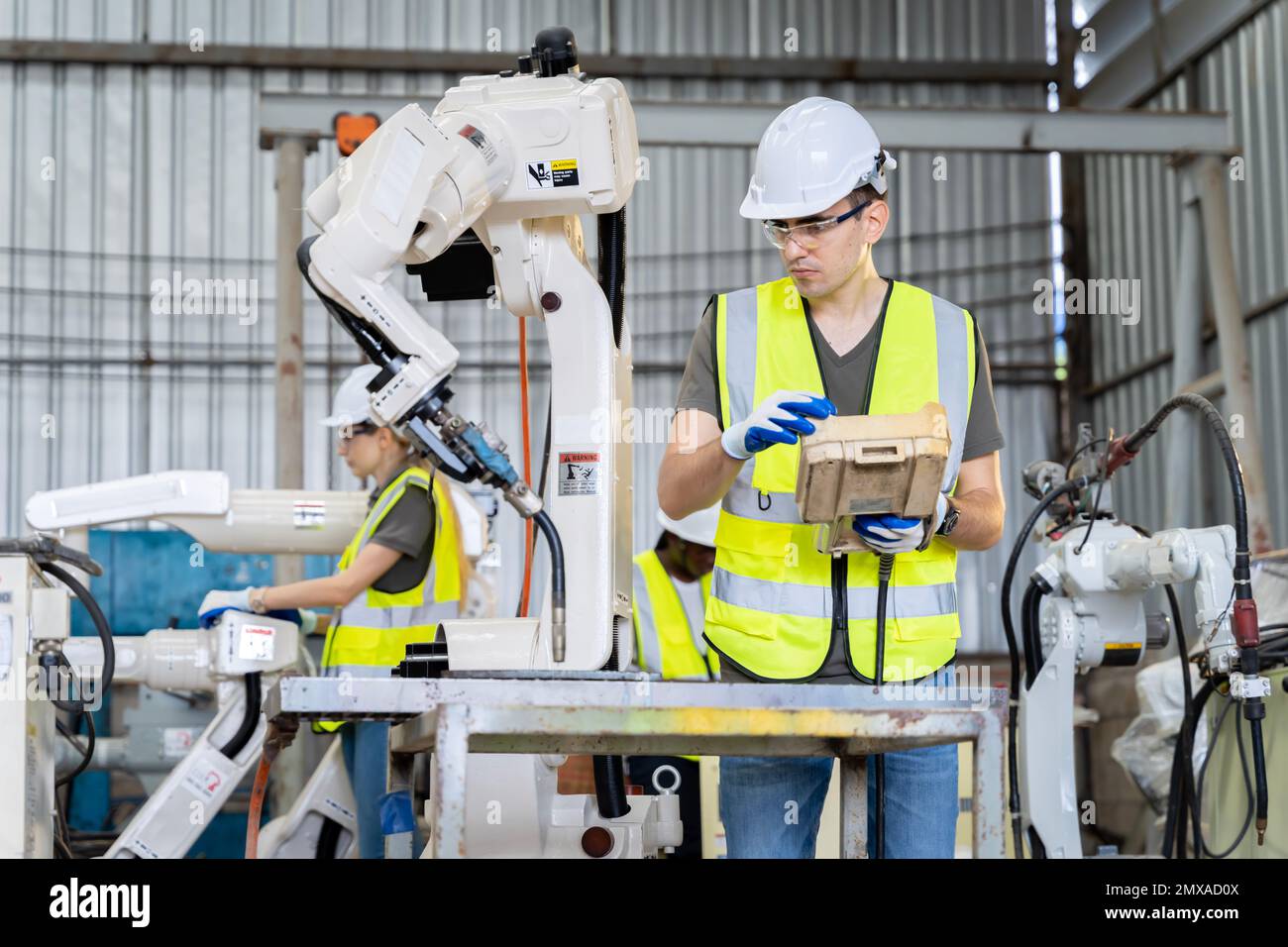 A team of male and female engineers meeting to inspect computer ...