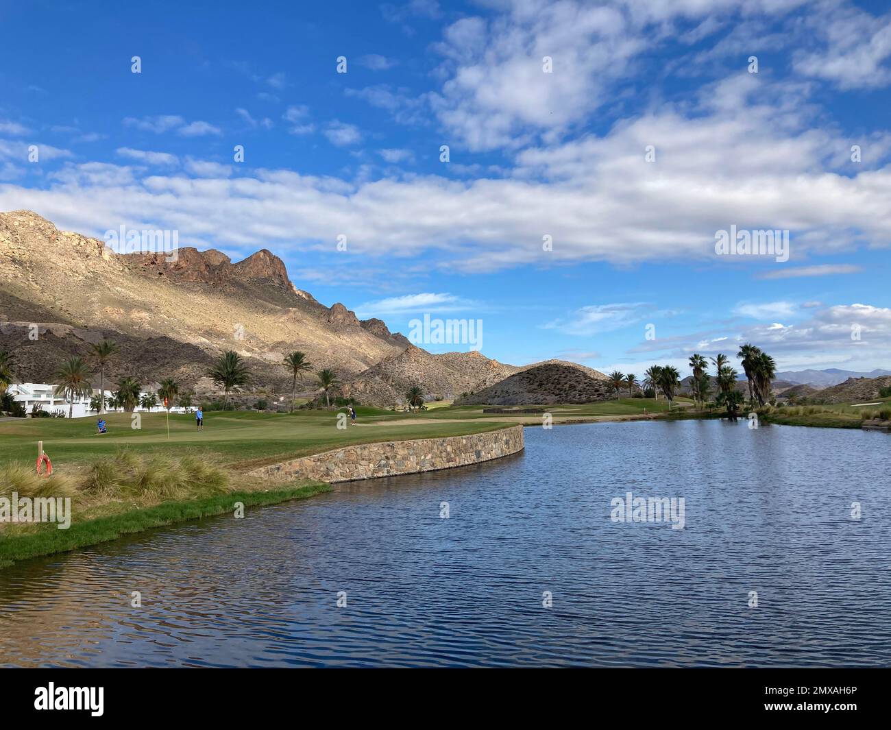 Aguilon Golf, golf course with palm trees and lake in front of the ...