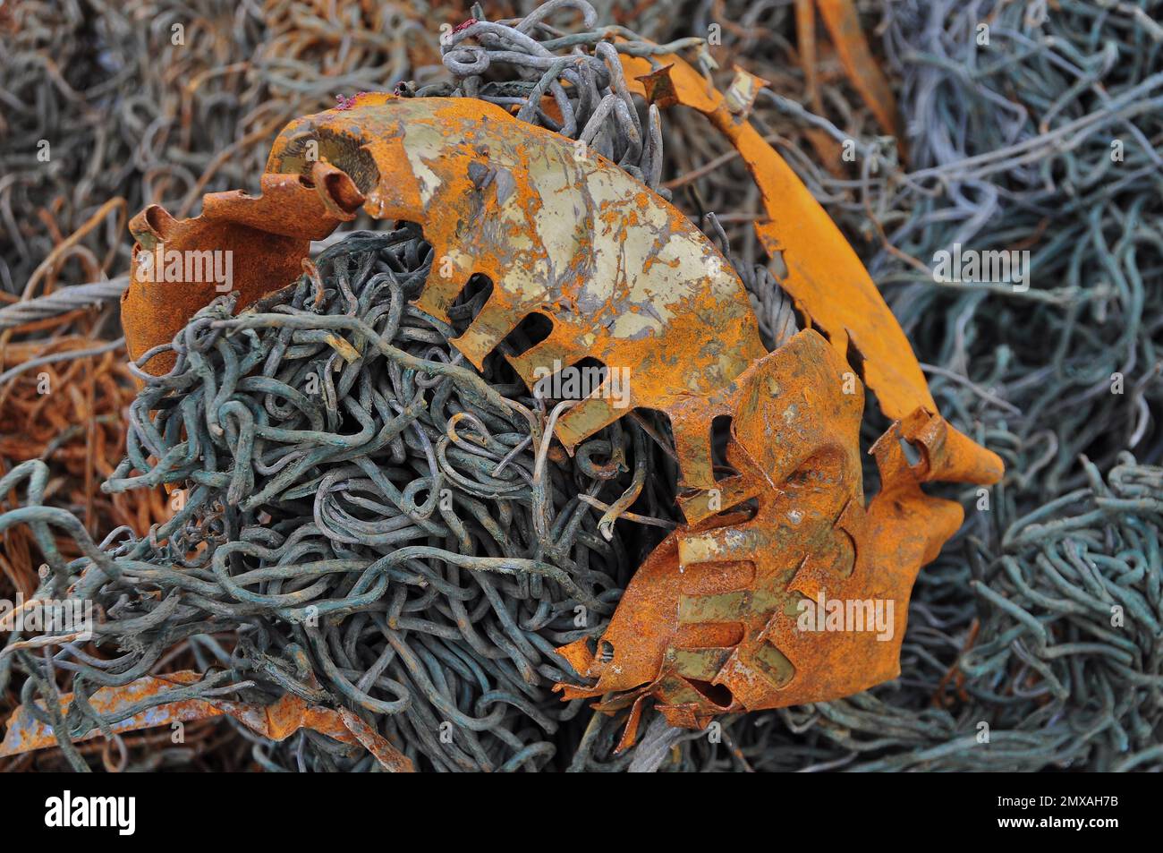 Piles of scrap metal, wires and punching waste, rusty, dented metal ...
