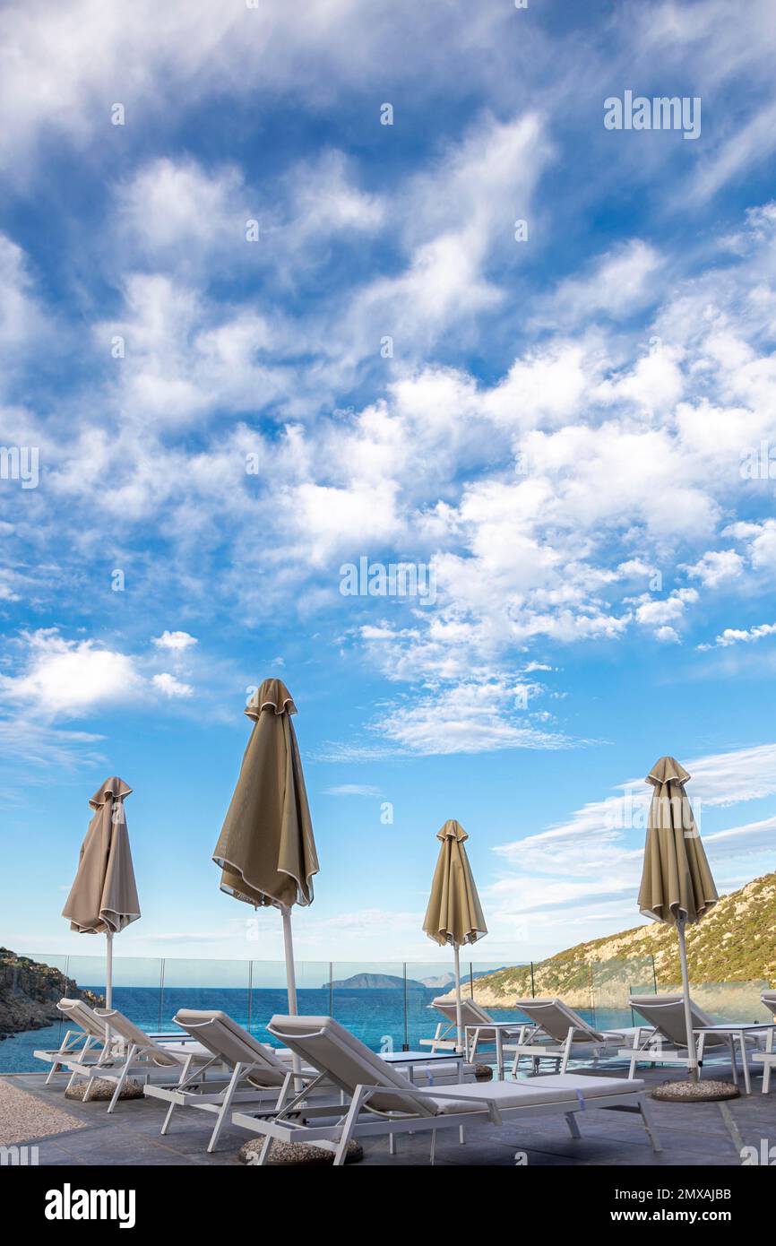 Parasols and sun loungers by the swimming pool, Crete, Greece Stock ...