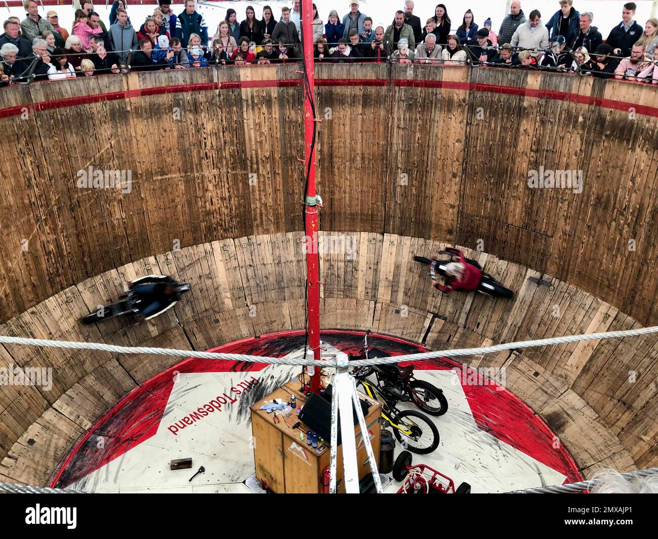 Spectators look down on motorcyclists on a steep wooden wall, Pitt's ...