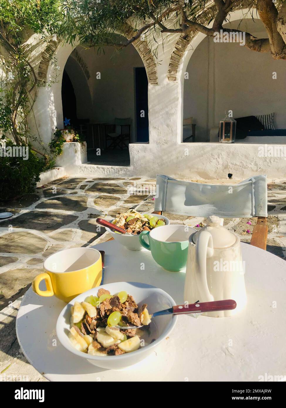 Breakfast with muesli and tea on a terrace, idyllic Cycladic house ...