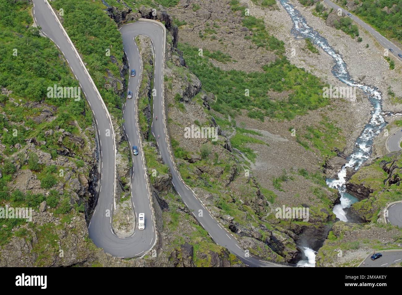 Mountain pass in Zig-Zag serpentines, barren mountains, wild stream ...