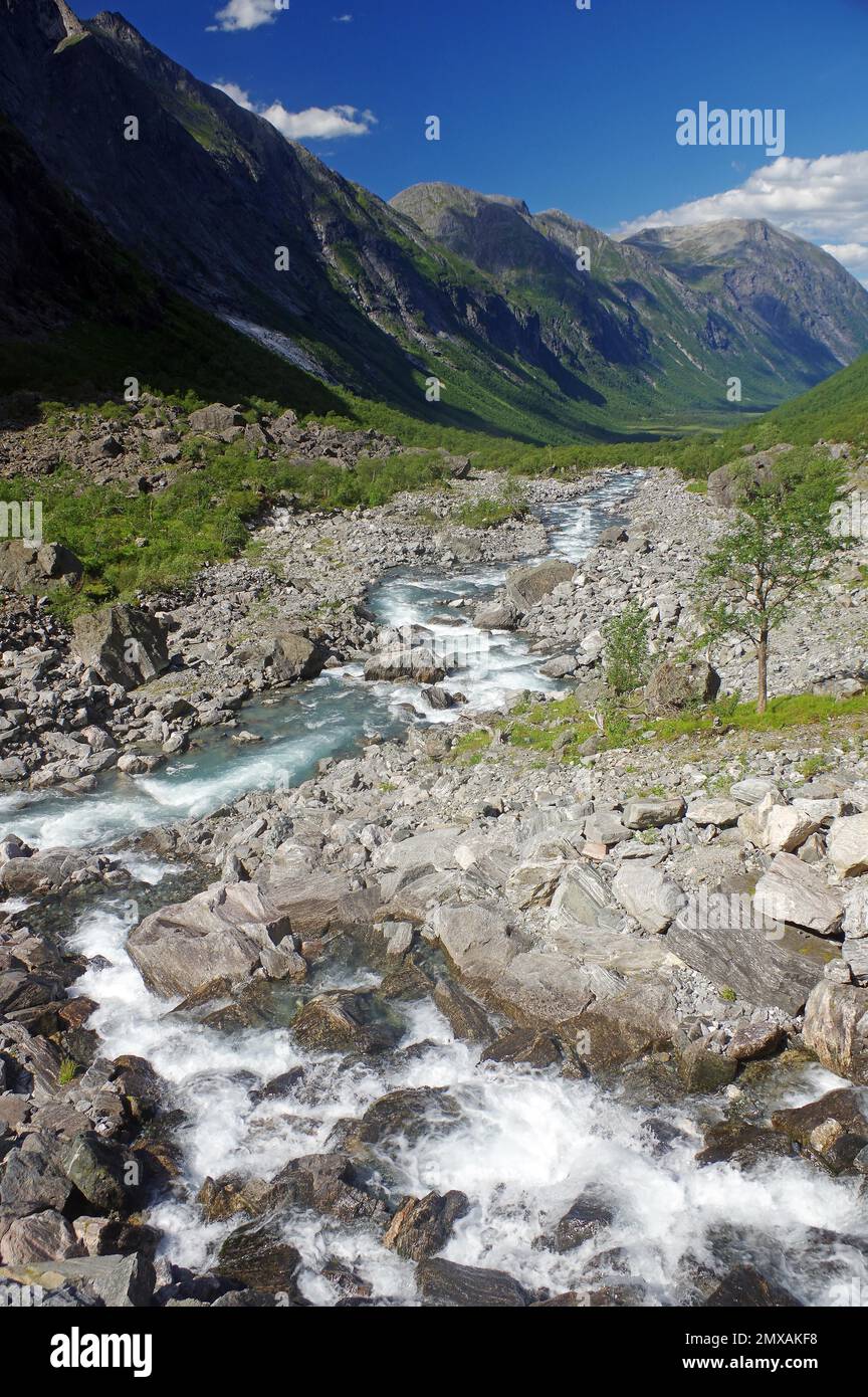 Wild stream in a narrow valley framed by mountains, Trollstigen, Norway ...