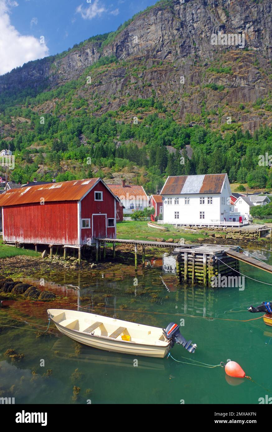 Wooden houses, small boat and jetties, high mountains, heritage ...