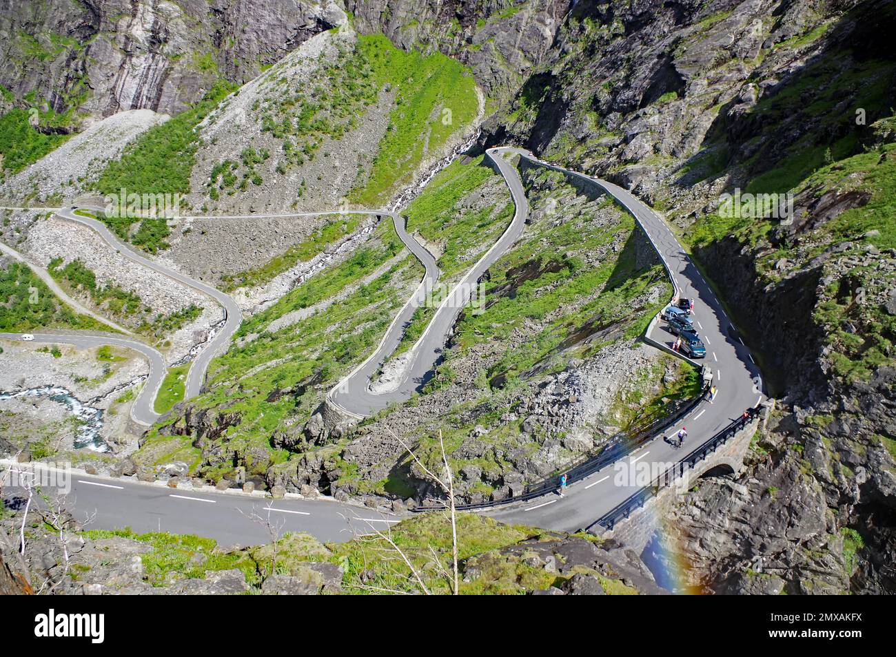 Mountain pass in zig-zag narrow switchbacks, barren mountains, rainbow ...