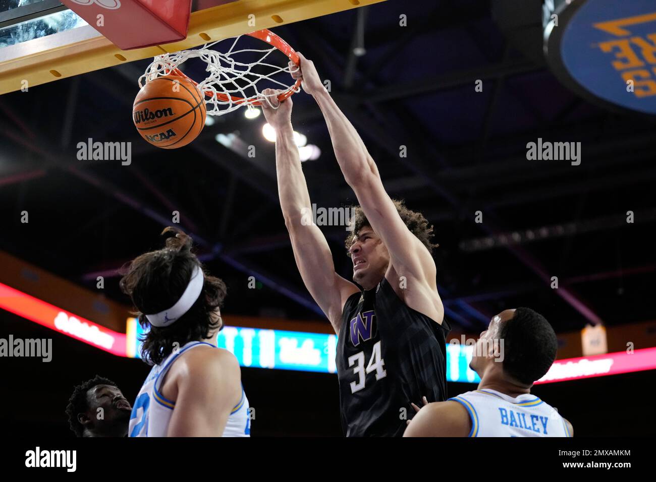 Washington center Braxton Meah (34) dunks against UCLA guard Jaime ...