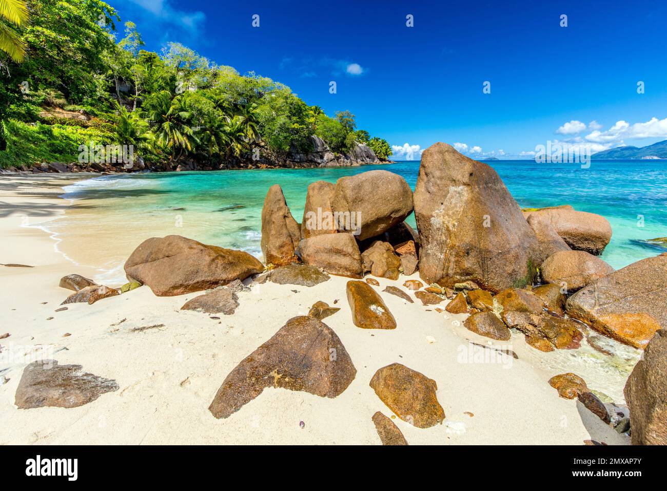 A scenic tropical beach in Baie Lazare on the island of Mahe ...