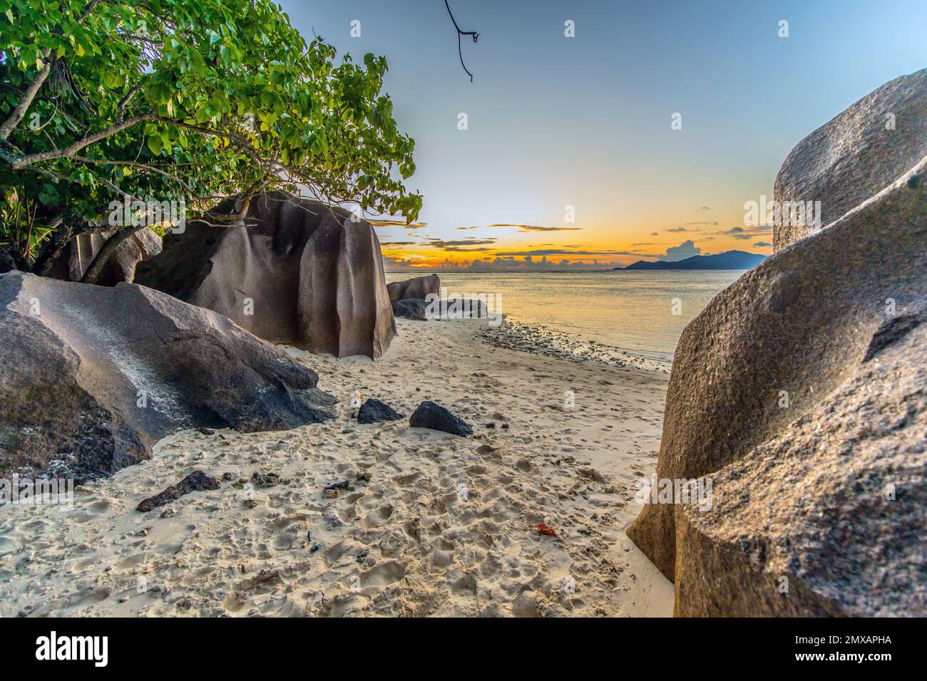 Anse Source d'Argent beach at sunset on La Digue island in the ...
