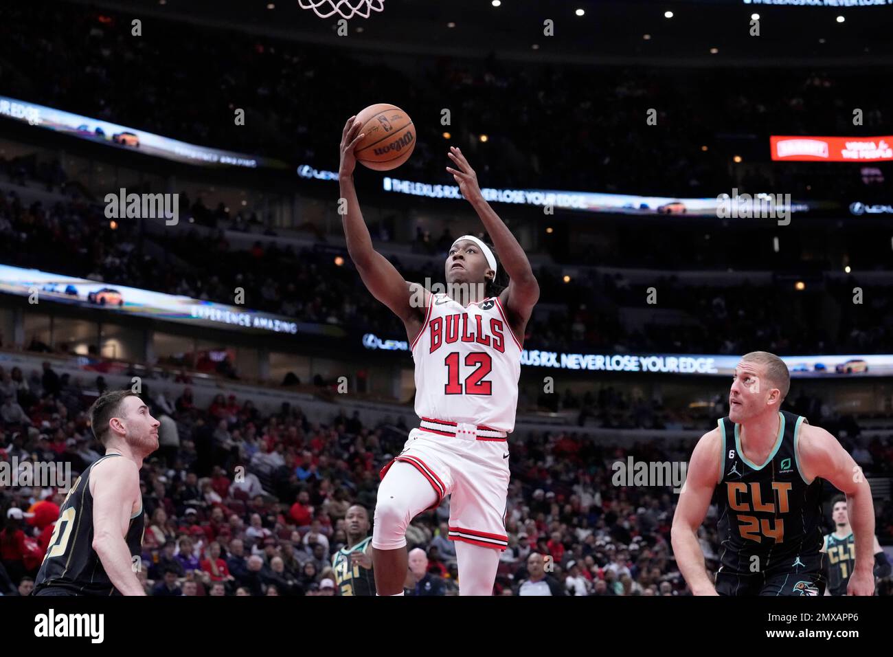 Chicago Bulls' Ayo Dosunmu (12) scores between Charlotte Hornets ...