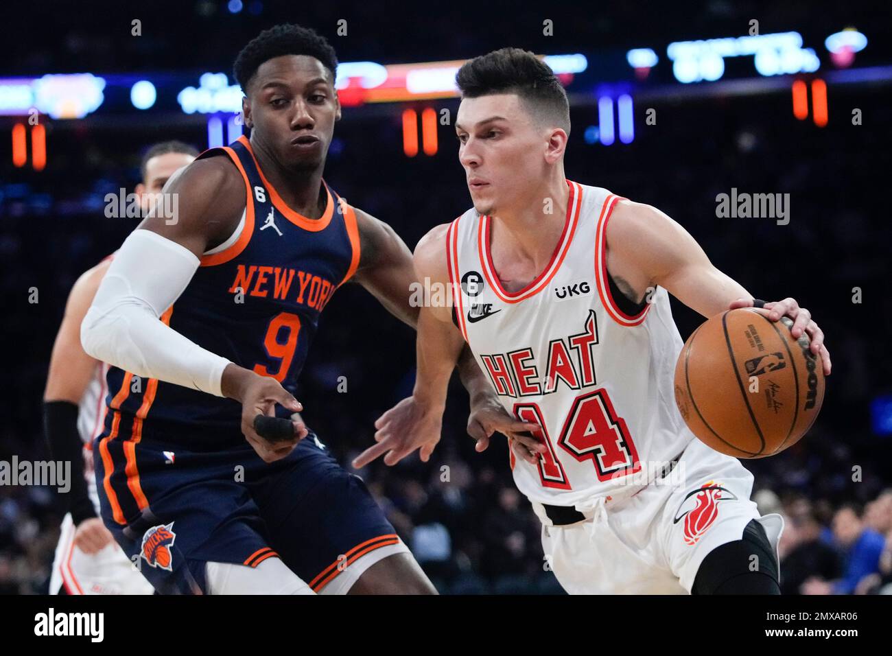 Miami Heat's Tyler Herro (14) drives past New York Knicks' RJ Barrett ...