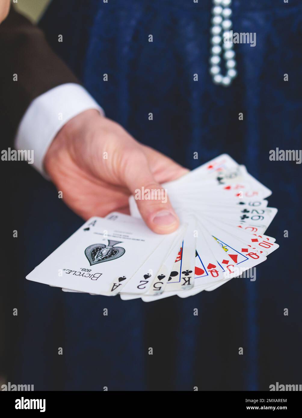 Magician illusionist with a deck of cards showing card tricks focus in ...