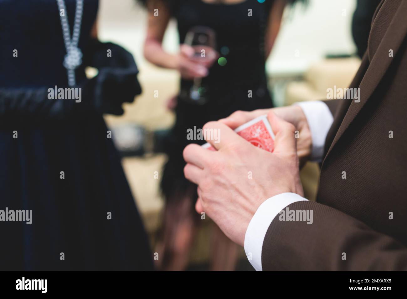 Magician illusionist with a deck of cards showing card tricks focus in ...
