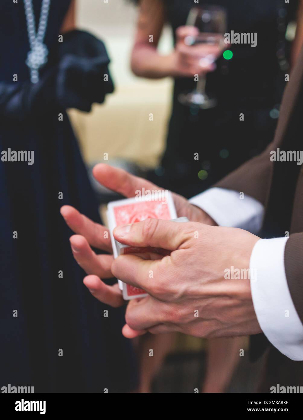 Magician illusionist with a deck of cards showing card tricks focus in ...