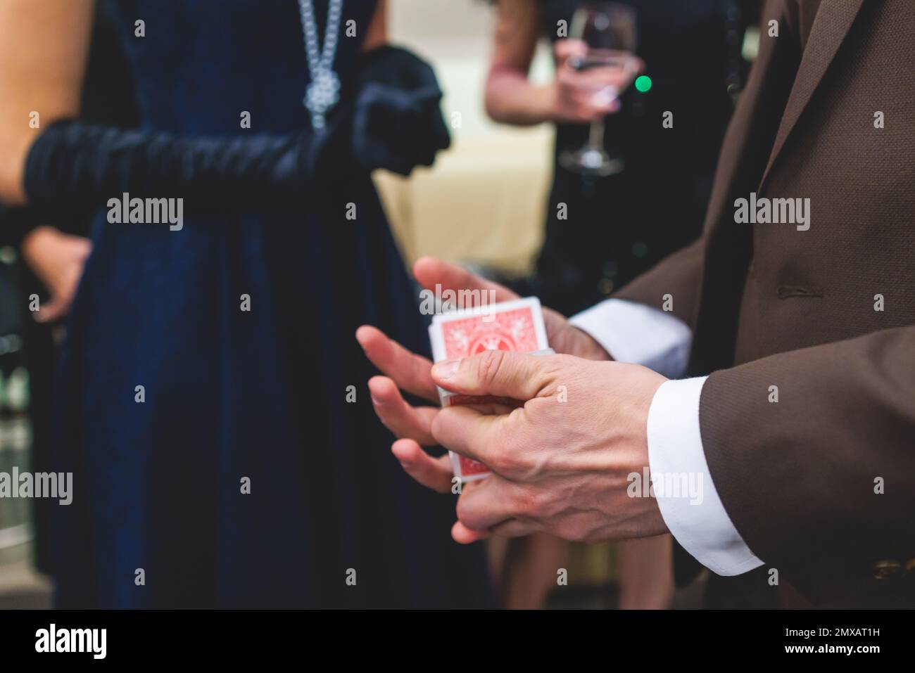 Magician illusionist with a deck of cards showing card tricks focus in ...