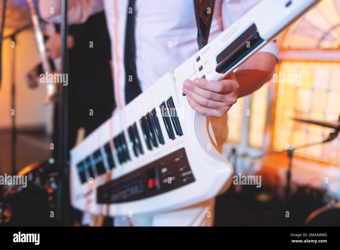 Concert view of a keytar synthesizer player with vocalist and musical ...